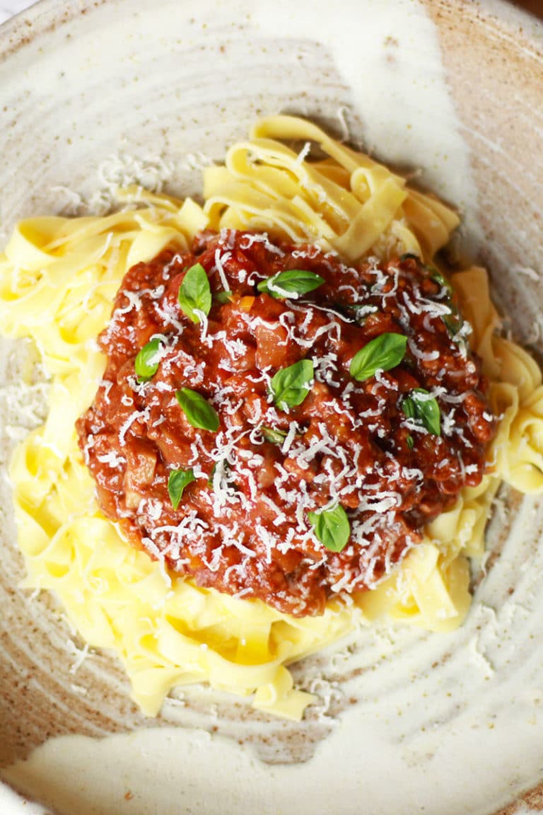 A lusciously, rich and tomatoey slow cooker Ragu, served with a mound ...